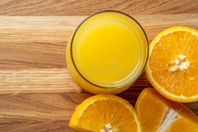 Glass and Jug of Orange Juice on a Wooden Stand, Sliced Orange Stock ... Glass and Jug of Orange Juice on a Wooden Stand, Sliced Orange Stock ...