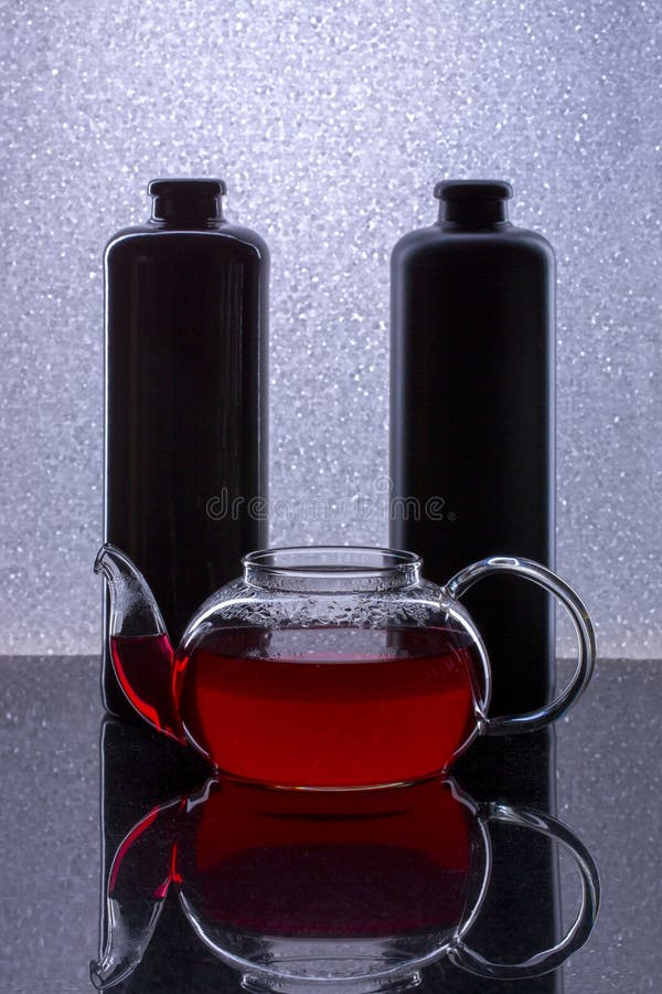 Glass Kettle with Red Liquid and Two Dark Bottles Stock Photo - Image ...