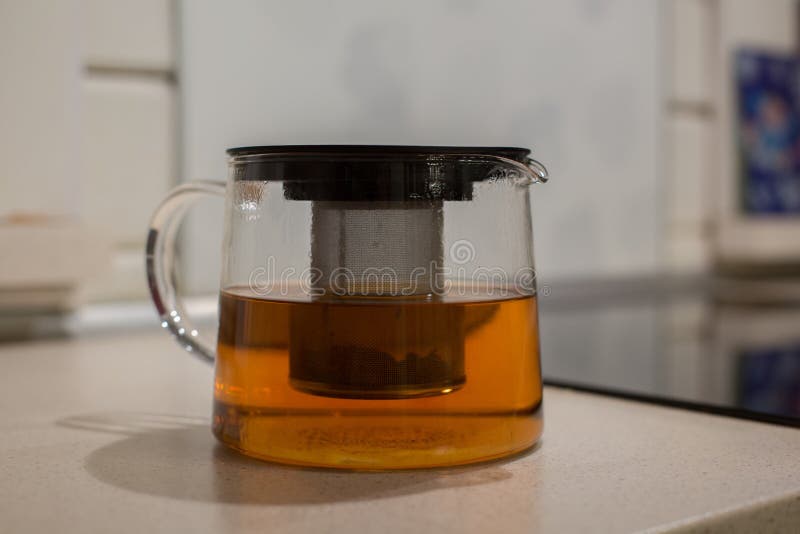 Glass Kettle with Tea on Cream Table (front View) Stock Image - Image ...