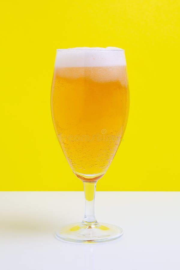 Glass of Lager Beer on a Yellow Background Stock Image - Image of full ...