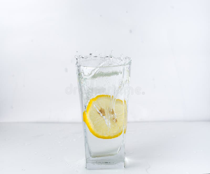 A glass with a lemon stock image. Image of drop, fresh - 76956489