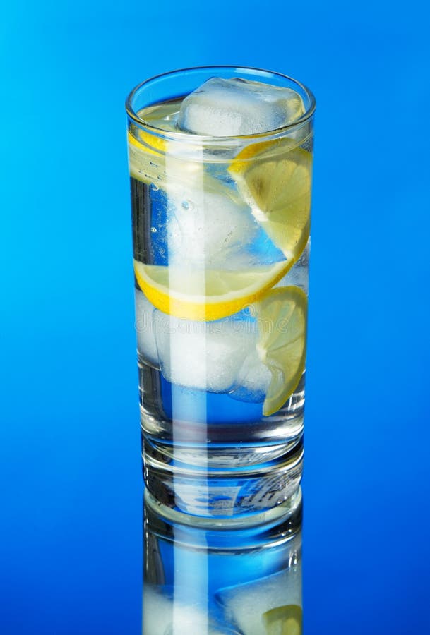 Glass of Lemon Ice Water on Blue Background Stock Image - Image of aqua ...