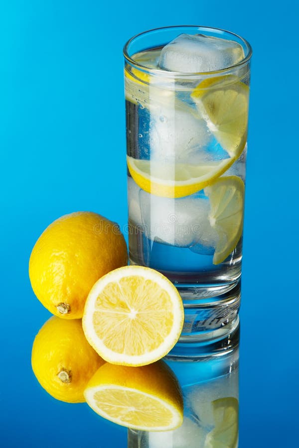 Glass of Lemon Ice Water on Blue Background Stock Image - Image of ...