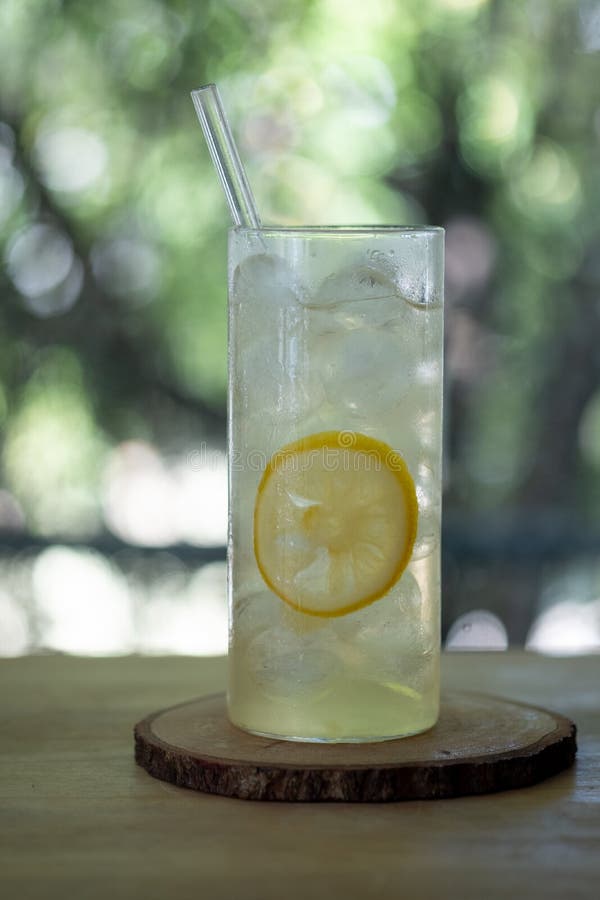 Glass with Lemon Water and Ice Cubes Stock Image - Image of drop, cold ...