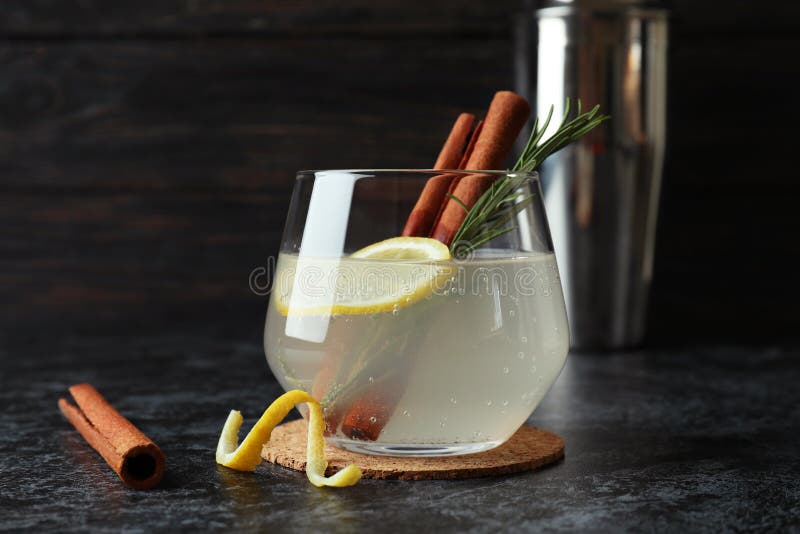 Glass of Lemonade with Cinnamon and Rosemary on Black Smokey Table ...