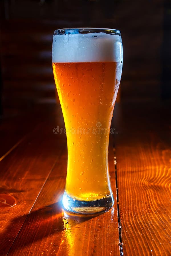 Glass of Light Beer on a Dark Pub Stock Image - Image of glass, brewed ...