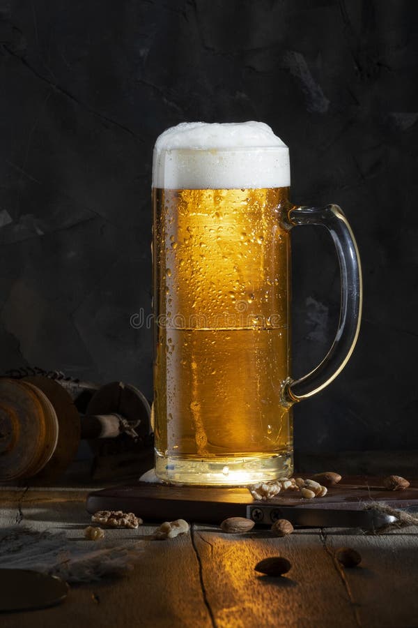 Glass of Light Beer with Foam on a Wooden Table Stock Image - Image of ...