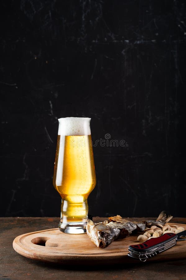 A Glass of Light Beer and Salted Fish. Beer Lager and Snacks Stock ...