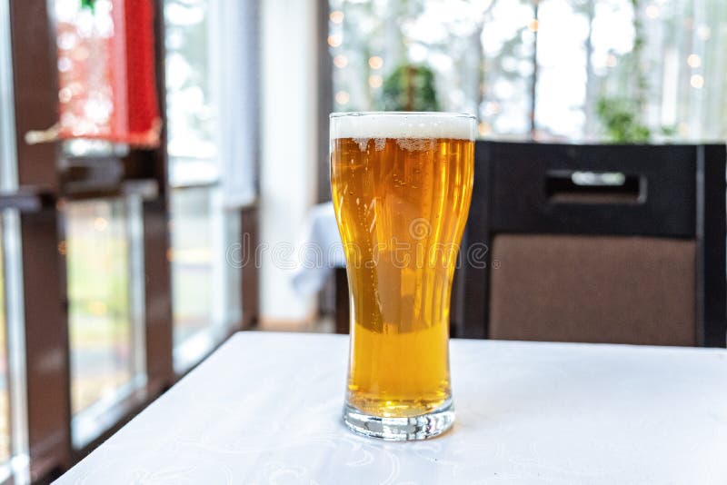 Glass of Light Beer on a Table in a Bar Stock Image - Image of golden ...