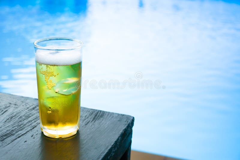 Glass of the Light Beer on the Wooden Table at Pool Stock Image - Image ...