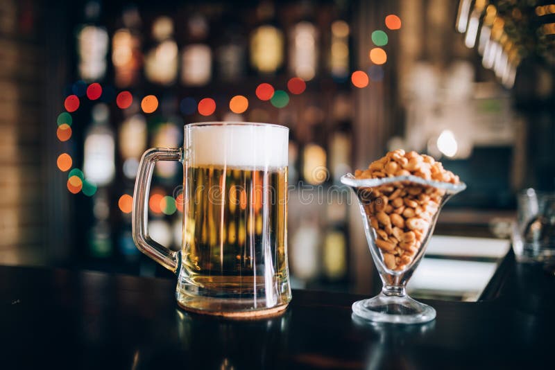 Glass of Light Cold Frothy Beer, Nuts in Pub Stock Image - Image of ...