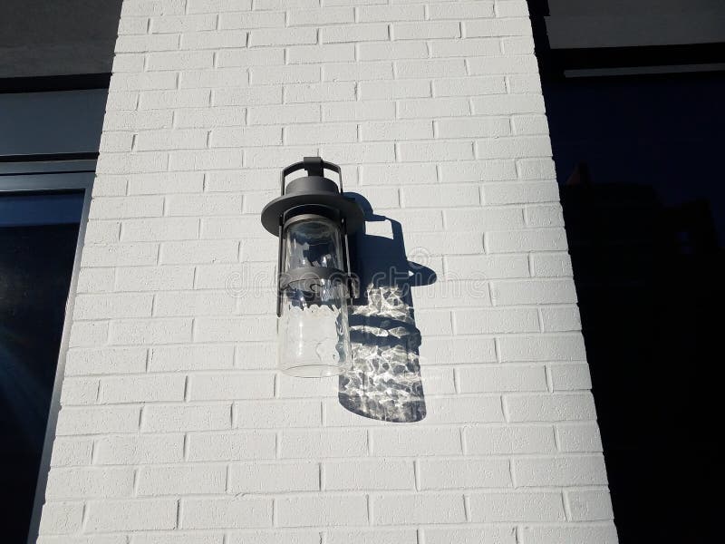 Glass Light with Reflection on White Brick Wall Stock Photo - Image of ...