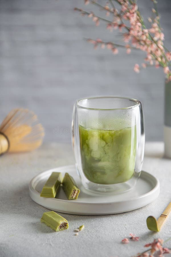 Glass of Matcha Latte with Matcha Chocolate on Gray Table Stock Image ...