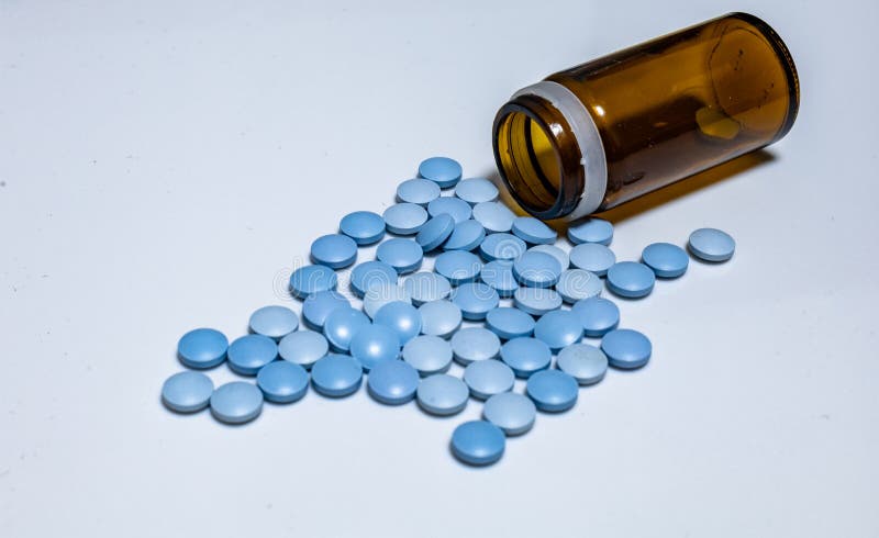 Glass Medicine Bottle, Blue Pills on White Table Stock Photo - Image of ...