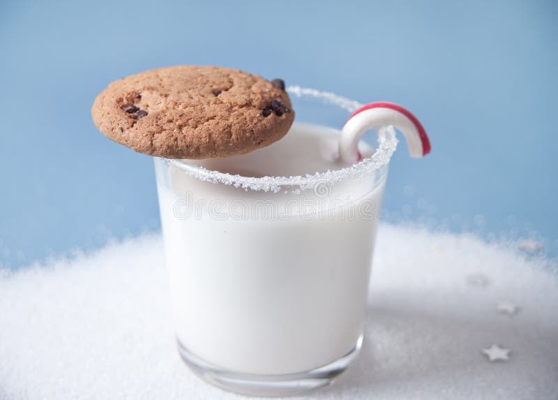 Glass of Milk, Cookie, Candy Cane on the Blue Background Stock Photo ...