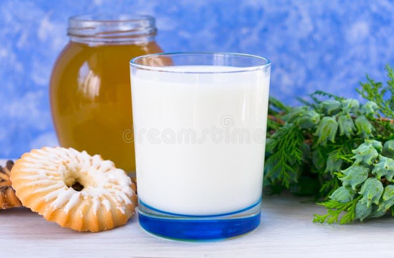 Glass of Milk with Cookies and Honey on the Table. on a Light Blue ...