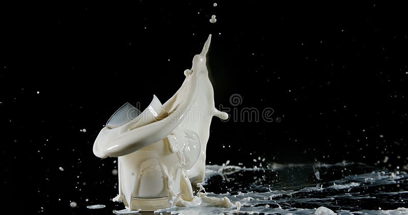 Glass of Milk Exploding Against White Background Stock Photo - Image of ...