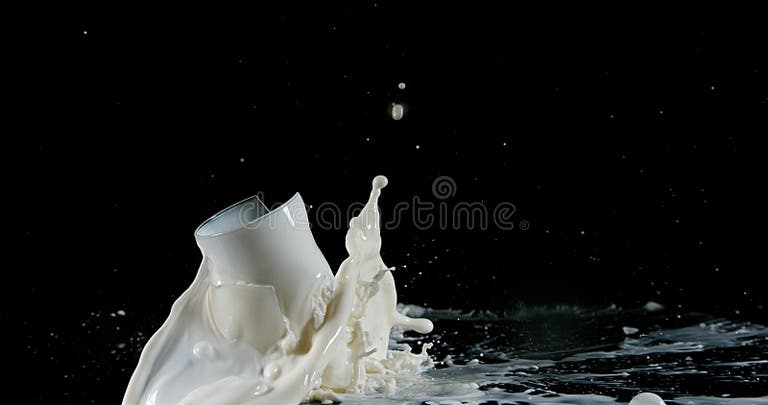 Glass of Milk Exploding Against White Background Stock Image - Image of ...