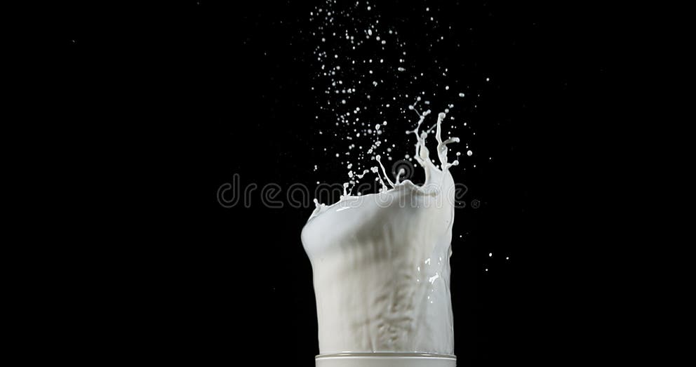 Glass of Milk Exploding Against White Background Stock Image - Image of ...