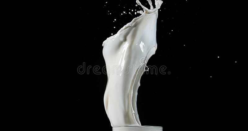 Glass of Milk Exploding Against White Background Stock Photo - Image of ...