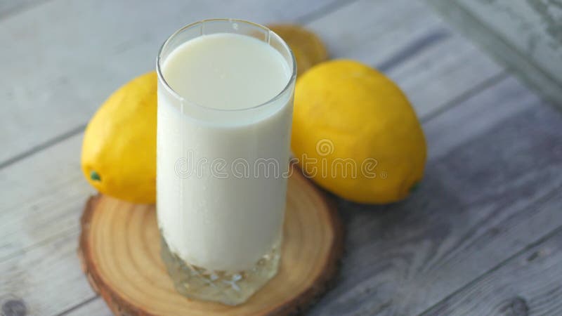 Glass of Milk and Lemon on Table Stock Video - Video of purity, liquid ...