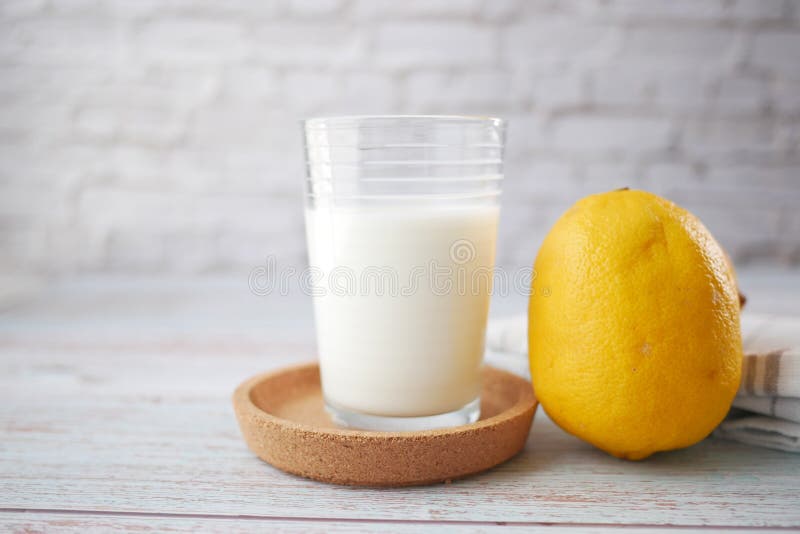 Glass of Milk and Lemon on Table Stock Image - Image of nutritious ...