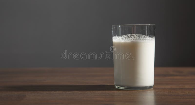 Glass of milk on the table stock photo. Image of product - 311362868