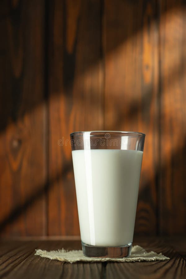 Glass of Milk on Wooden Table with Sun Rays Stock Photo - Image of ...
