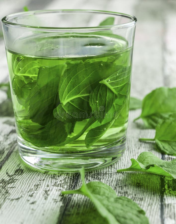 Glass of Mint Tea and a Bunch of Mint on the Table Stock Image - Image ...