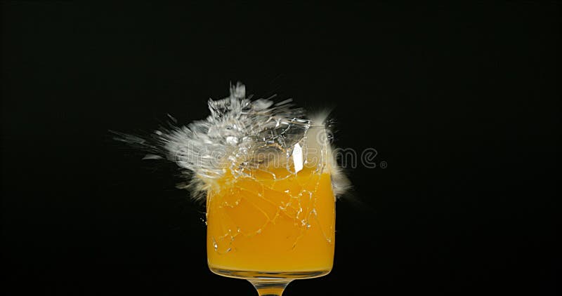 Glass of Orange Exploding Against Black Background Stock Photo - Image ...