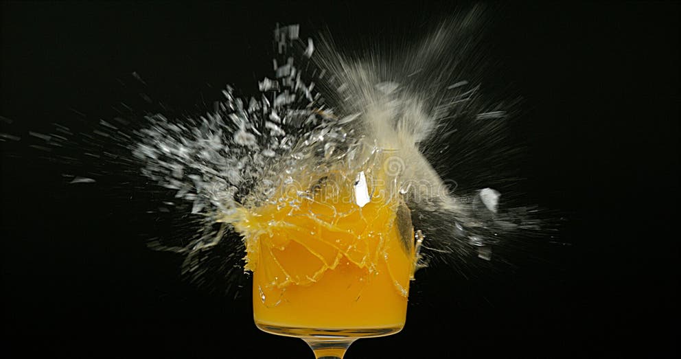 Glass of Orange Exploding Against Black Background Stock Photo - Image ...