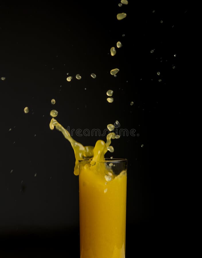 Glass of Orange Juice with Splash, on Black Background Stock Photo ...