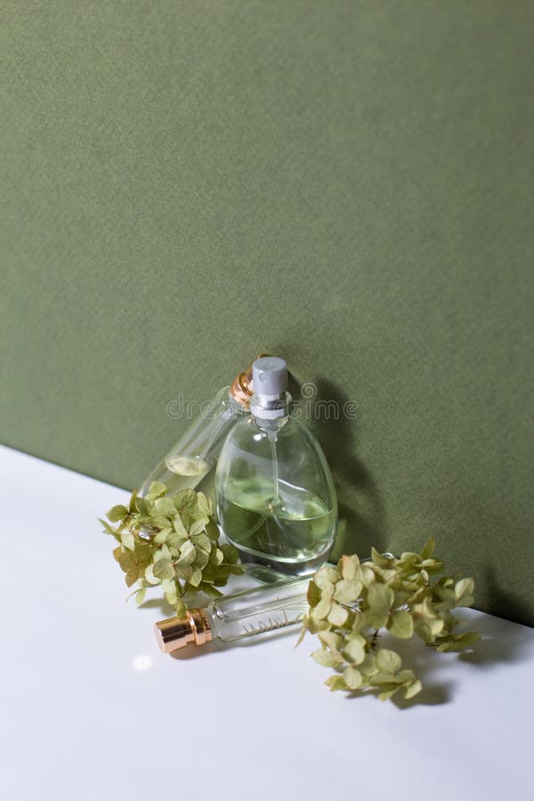 Glass Perfume Bottles with Sprigs of Hydrangea on a Light Background ...