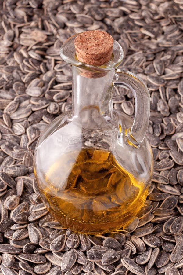 Glass Pitcher of Sunflower Oil on the Sunflower Seeds Stock Image ...