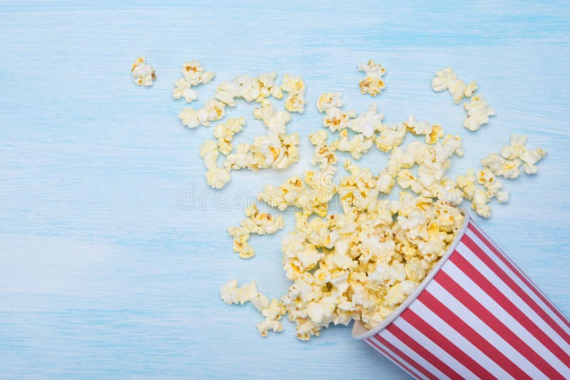 Glass of Popcorn, Scattered on a Blue Background Stock Image - Image of ...