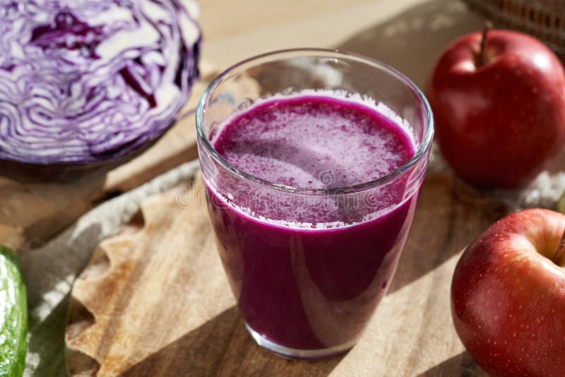 A Glass of Purple Cabbage Juice with a Head of Red Cabbage and Apples ...