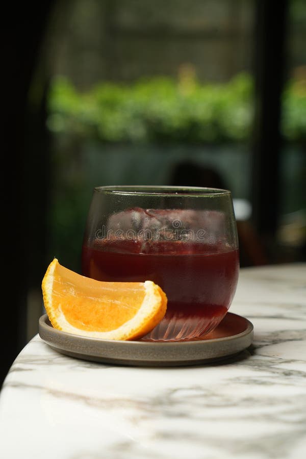 Glass of Red Cocktail with Ice Cube and Orange Slice Stock Image ...