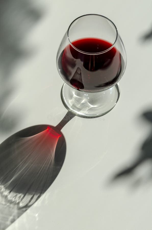Glass of Red Ruby Port Wine on White Table with Shadows Stock Photo ...
