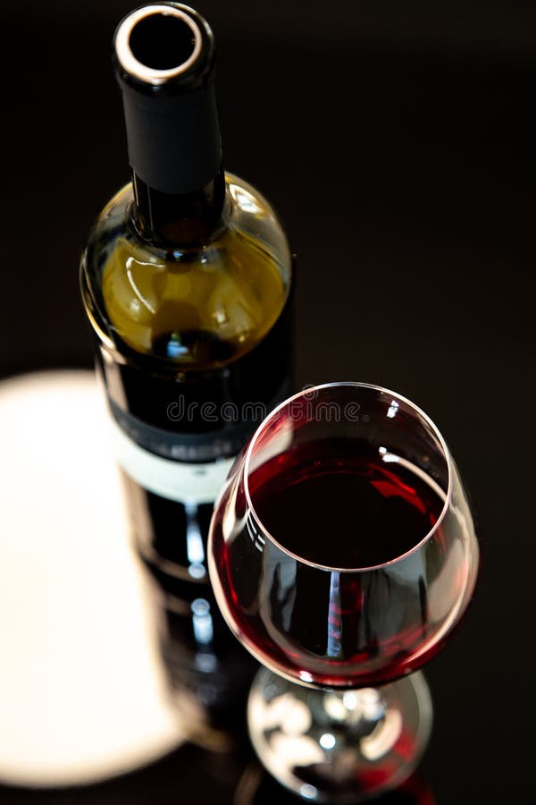 A Glass of Red Wine with a Bottle of Wine in Top View with a Background ...
