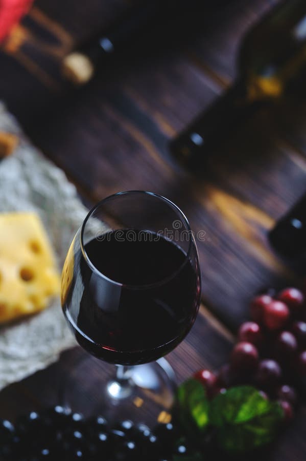 A Glass of Red Wine Cheese and Grapes Stock Photo - Image of label ...