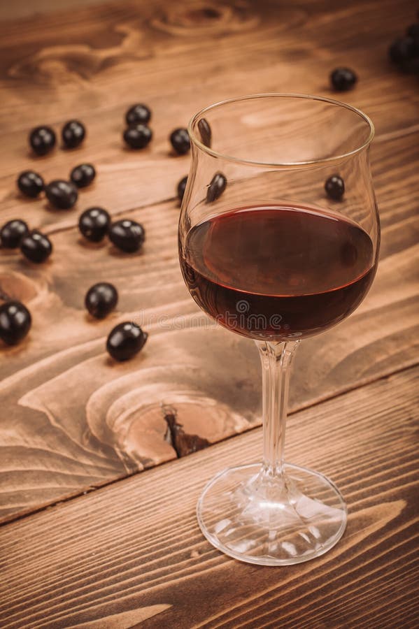 Glass of Red Wine and Grapes on Rustic Wood Table Stock Photo - Image ...