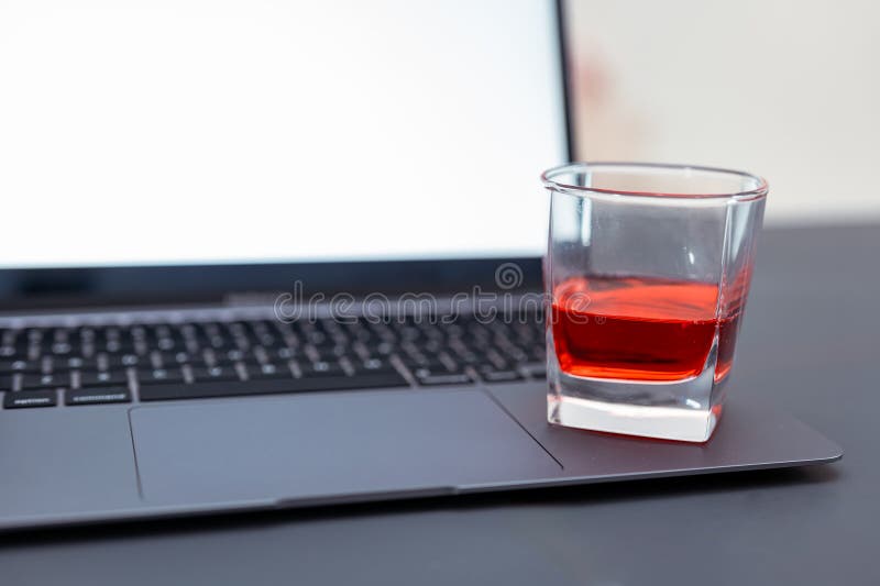 A Glass of Red Wine Sitting on Top of a Laptop Computer Stock Photo ...