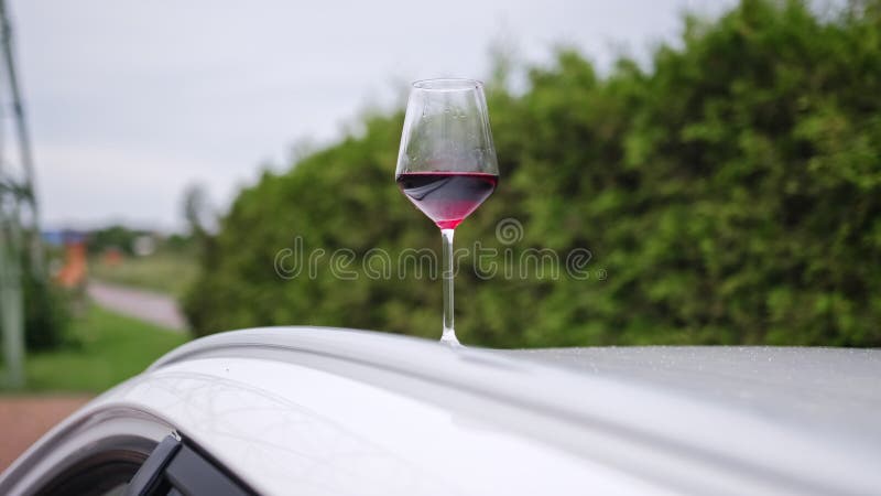 Glass of Red Wine Standing on Car Roof Stock Footage - Video of full ...