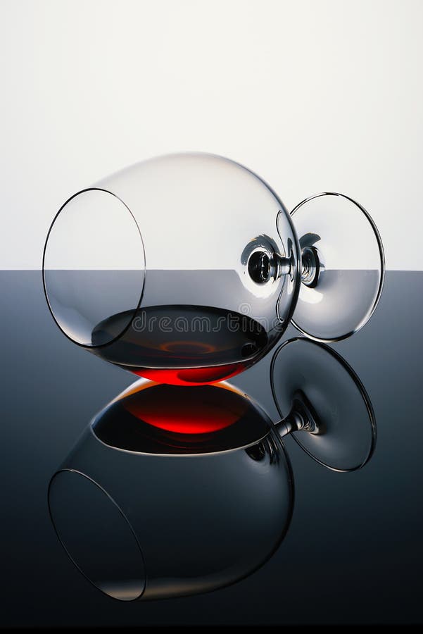 The Glass with the Remains of Alcoholic Drink Lies on the Reflecting ...