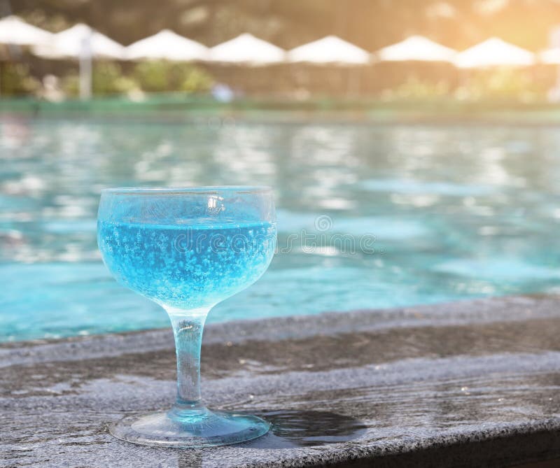 A Glass of Sparkling Drink on the Edge of the Pool Stock Photo - Image ...