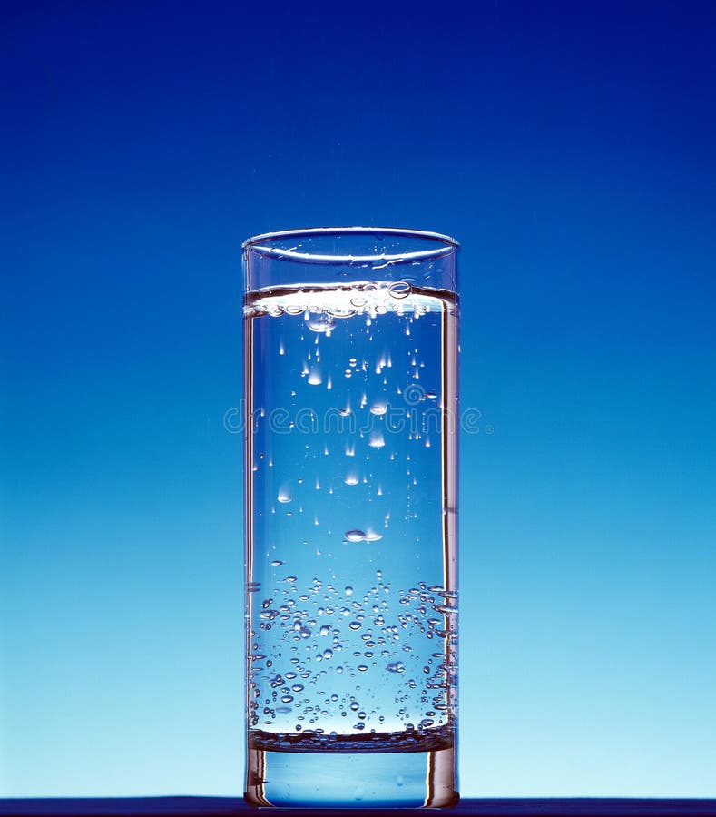 Glass of Sparkling Water Against Blue Background Stock Photo - Image of ...