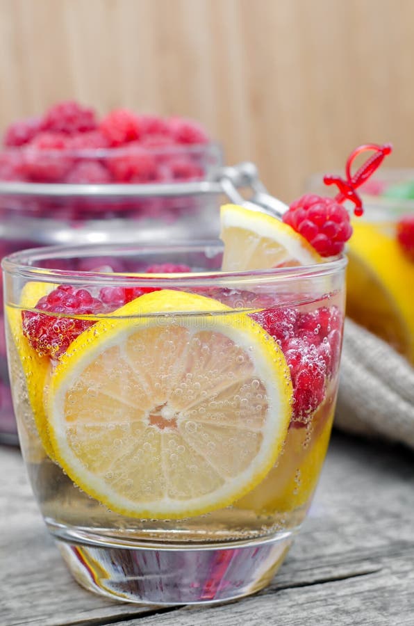 Glass of Sparkling Water with Lemon and Raspberry Stock Photo - Image ...