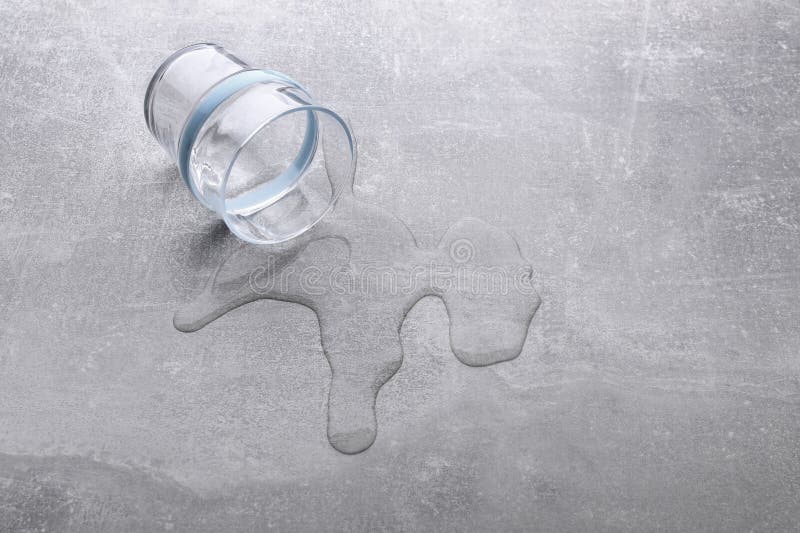 Glass with Spilled Water on Light Grey Surface. Space for Text Stock ...