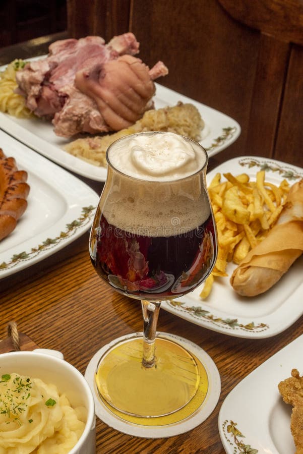 Glass of Strong German Beer Surrounded by Typical Dishes of Its ...