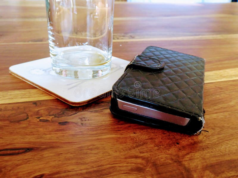 Glass on Table with Mobile Phone, Dinner Table with Phone. Stock Photo ...